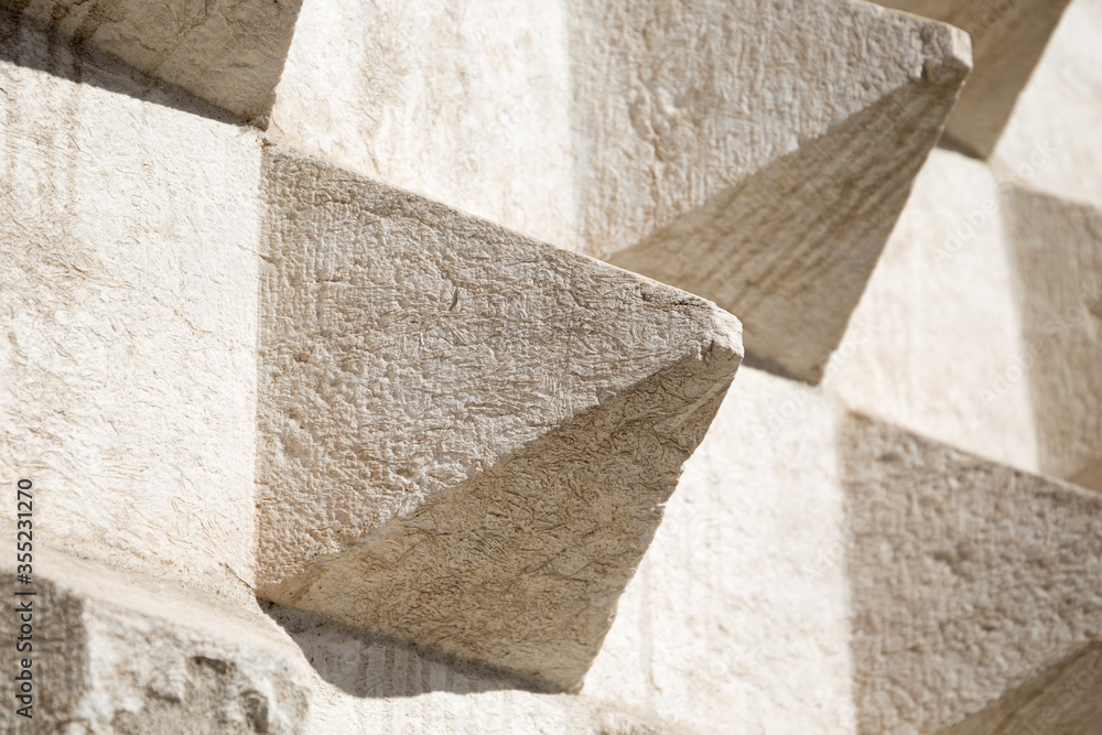 Stone wall texture: white facade consisting of little protruding ...