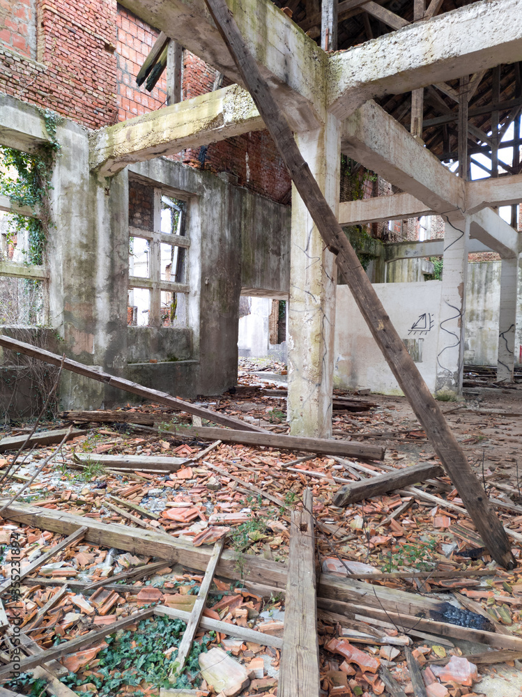 Demolished interior of a house. Rafters and shingles from the fallen ...