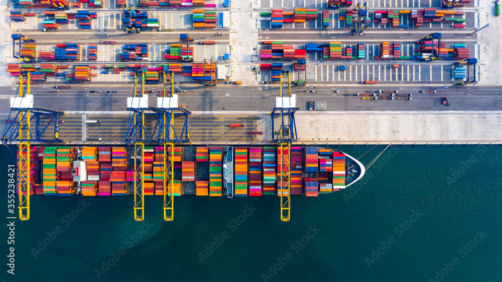 Aerial top view container ship at terminal seaport with tugboat, Global ...