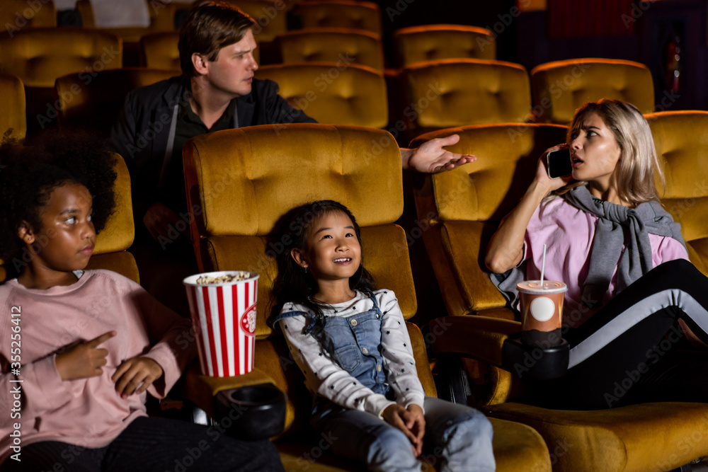 Foto de Caucasian woman talking on phone in the cinema and showing a ...