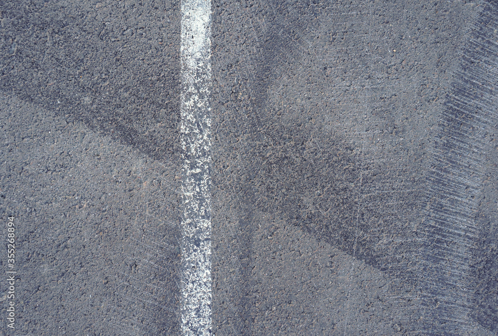 Asphalt texture with white line and tire marks. Smooth asphalt road ...