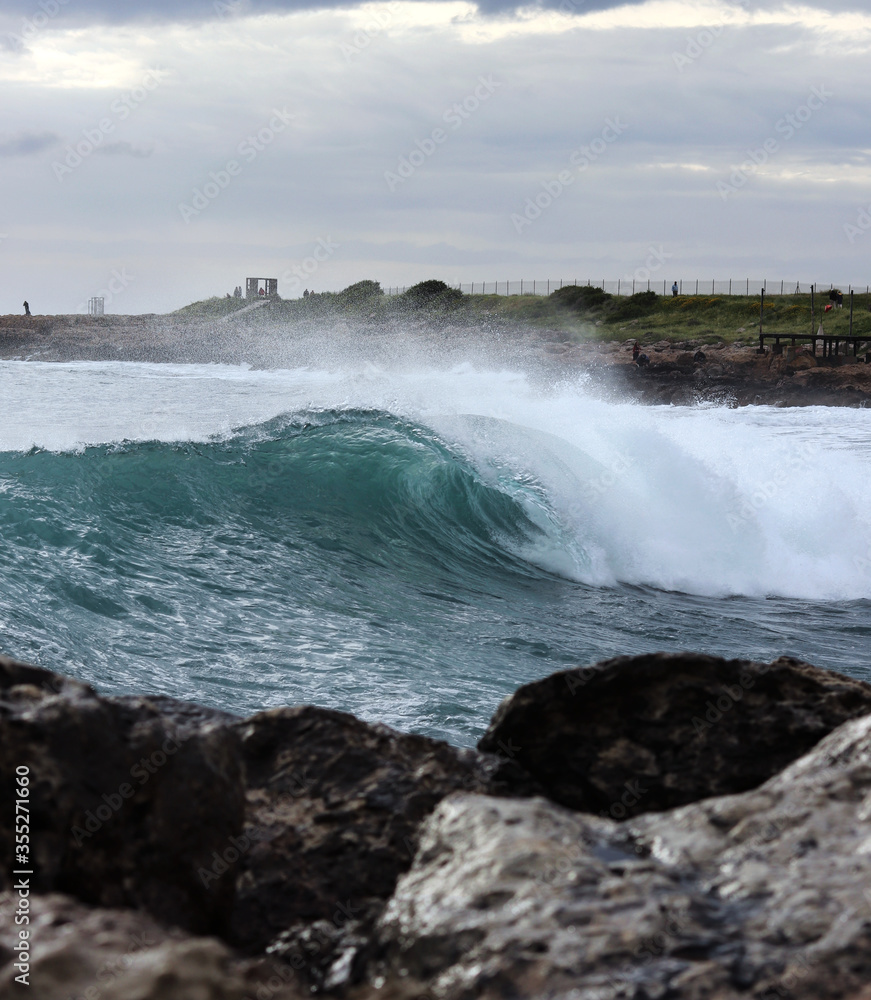 Side view of a beautiful clear wave that is just flipping and falling ...