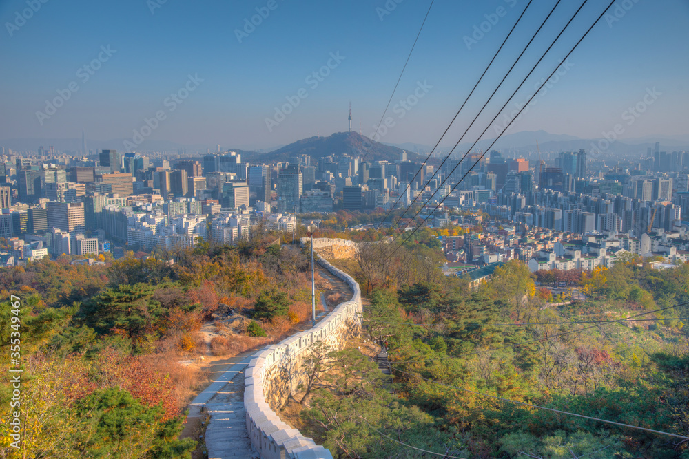 Sunset view of Namsan tower viewed behind an ancient wall at Inwangsan ...