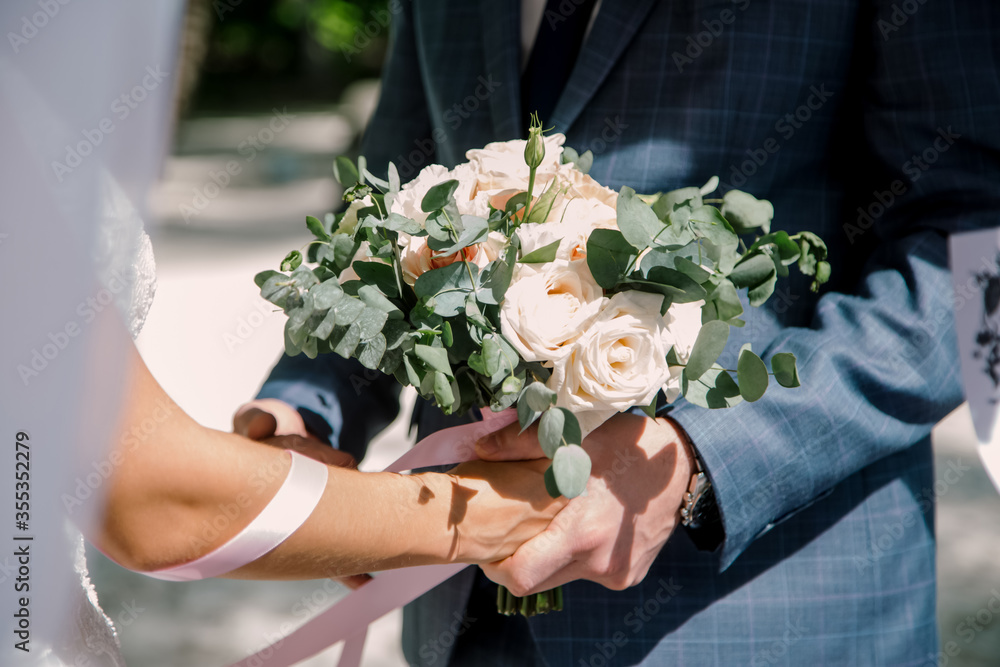 Newlyweds at the wedding romantic couple holding hands during ...