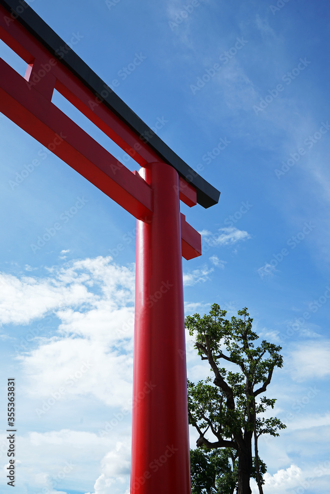 Traditional Japanese Shinto Torii gate with cloudy blue sky, the ...