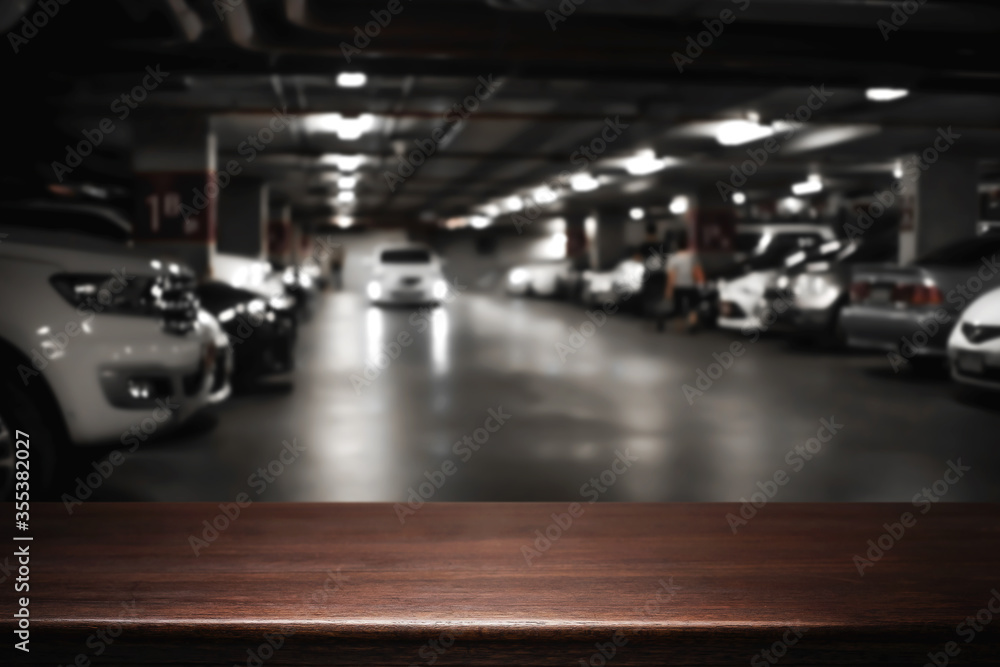 Empty desk platform over car park background. For product display ...
