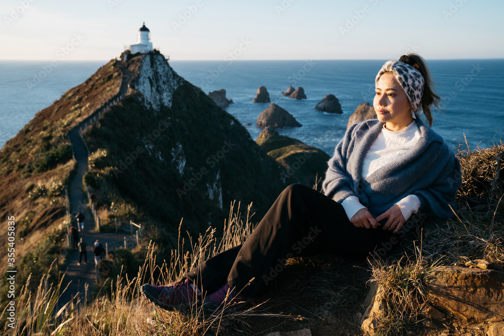 Beautiful asian tourist chilling out at Nugget Point, Dunedin, New ...