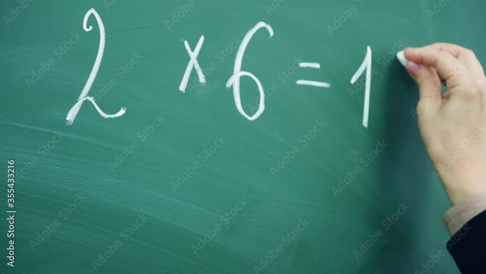Vídeo do Stock: Elementary school. Teacher writing numbers on green ...