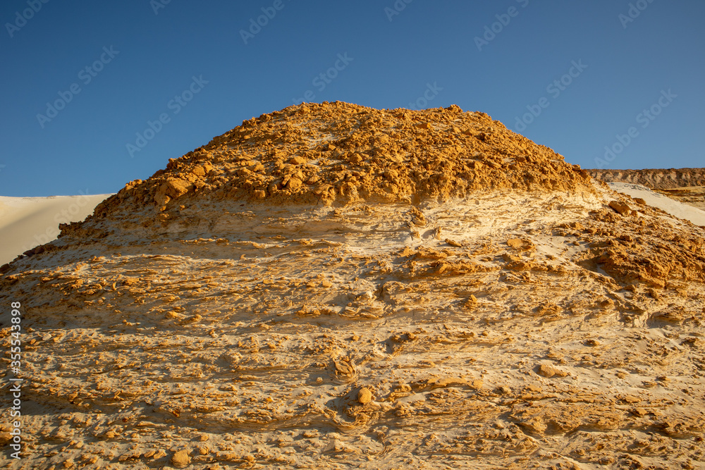 Desert landscape. Dunes of orange sand, sunny day, shadows on the sand ...