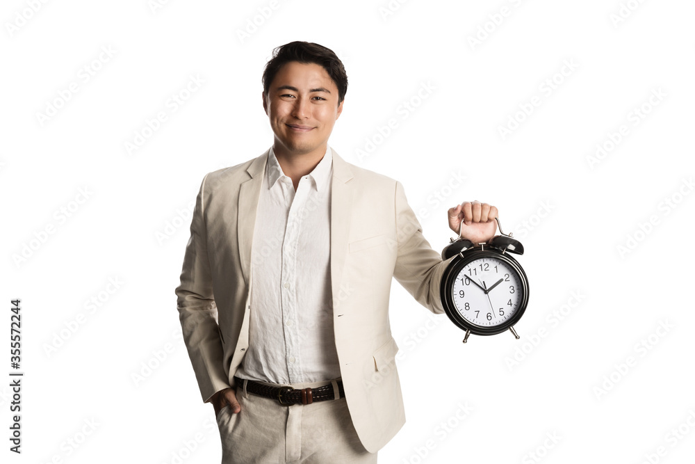 Image of a handsome smiling Asian man holding a huge alarm clock and ...