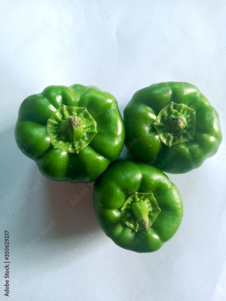 Three green capsicum from top view in a white background Stock Photo ...