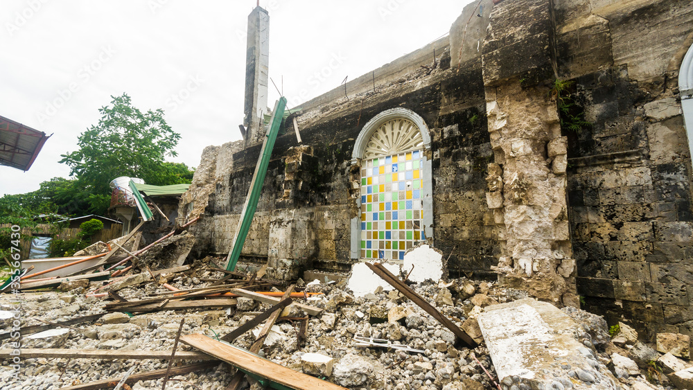 A heavily damaged church with intact stained glass windows. Caused by ...