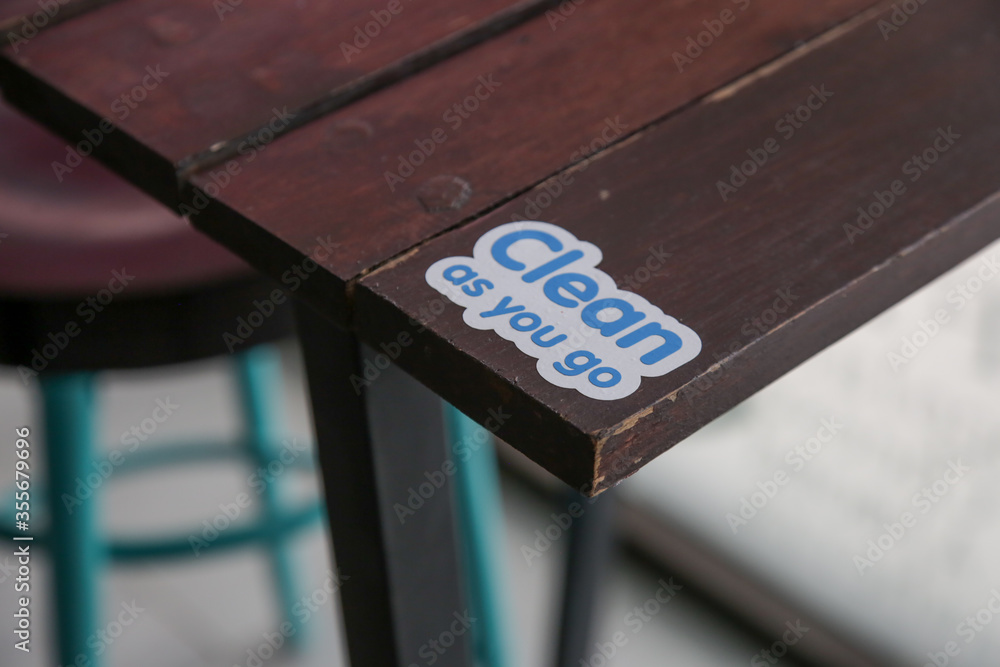 Clean as you go sticker on the restaurant table Stock Photo | Adobe Stock