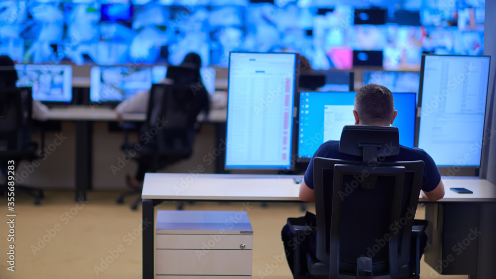 male operator working in a security data system control room Stock ...