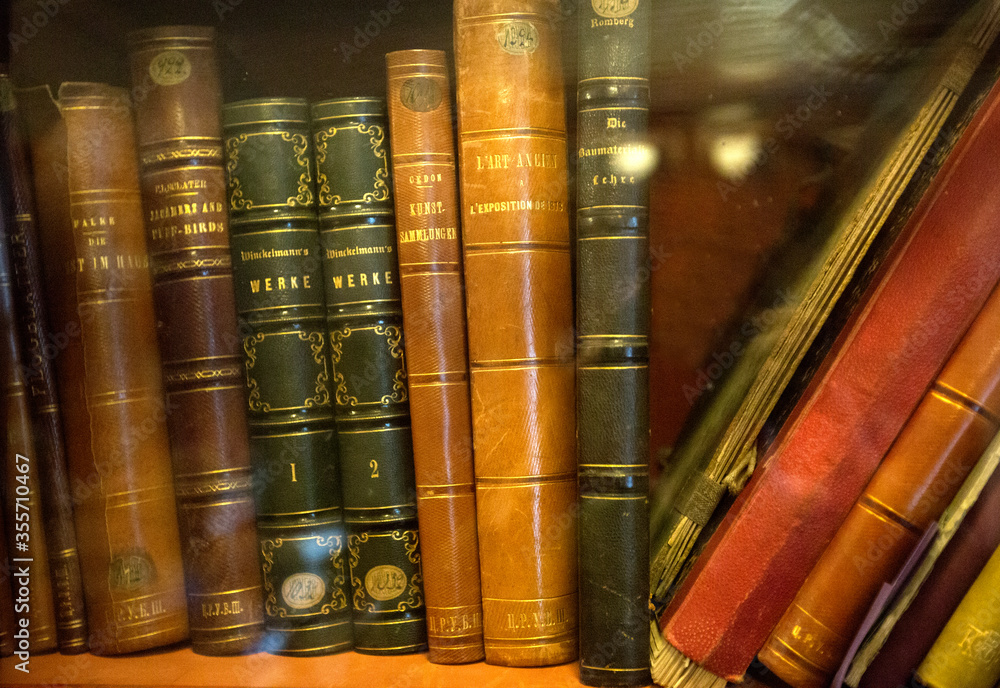 Bookshelf in old library with many books. Interior of an old library ...