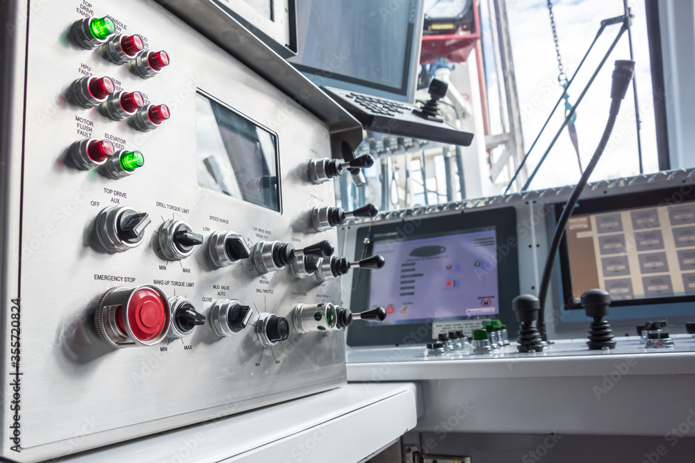 Oil rig computer controls & switches in operators room on rig floor ...