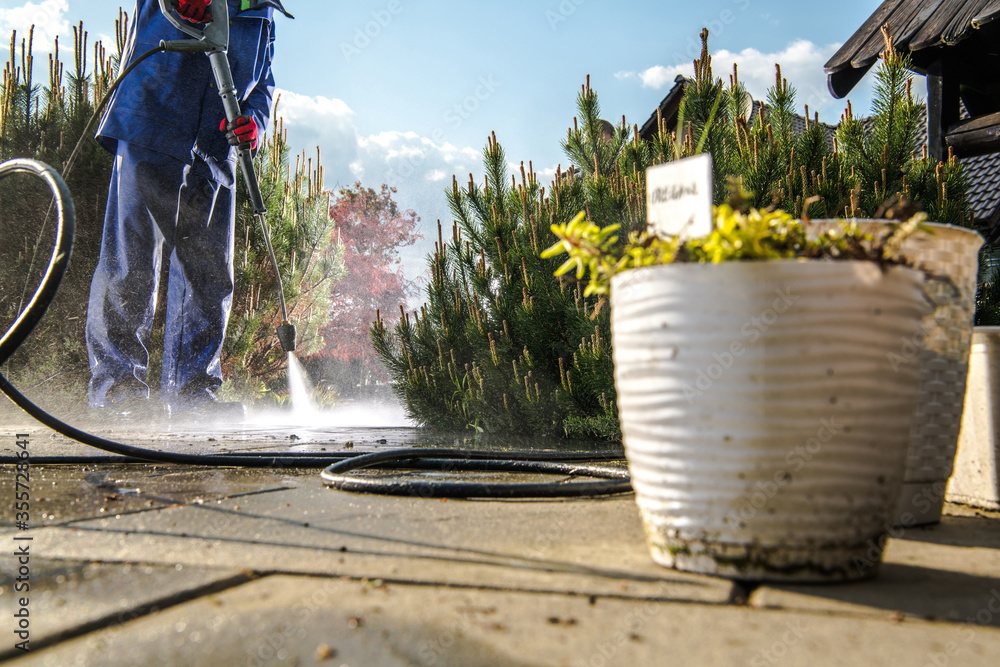 Cleaning Garden Paths Using Pressure Washer Stock Photo | Adobe Stock