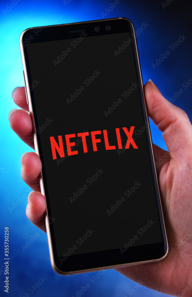 Hand holding smartphone displaying logo of Netflix Stock Photo | Adobe ...