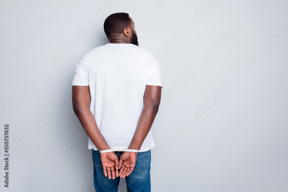Rear behind photo of dark skin african guy criminal tied rope arms ...
