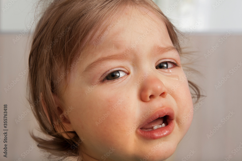 Crying baby with tears in his eyes. Children's tantrums, manipulations ...