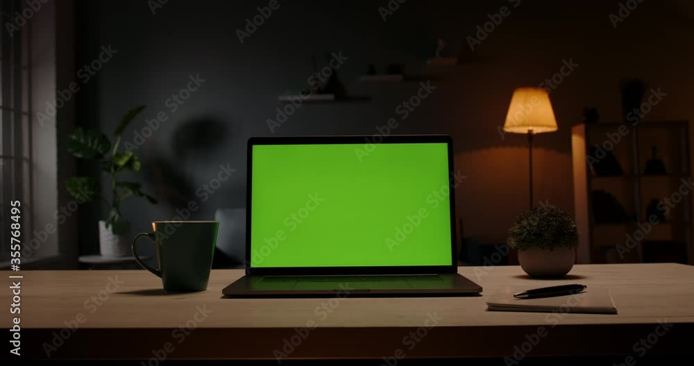 Chroma key green screen template - a laptop computer on a desk in cozy ...