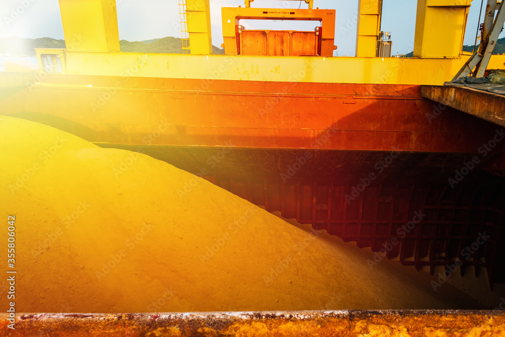 Raw sugar bulk loaded into large vessel hole for export. Sugar bulk ...