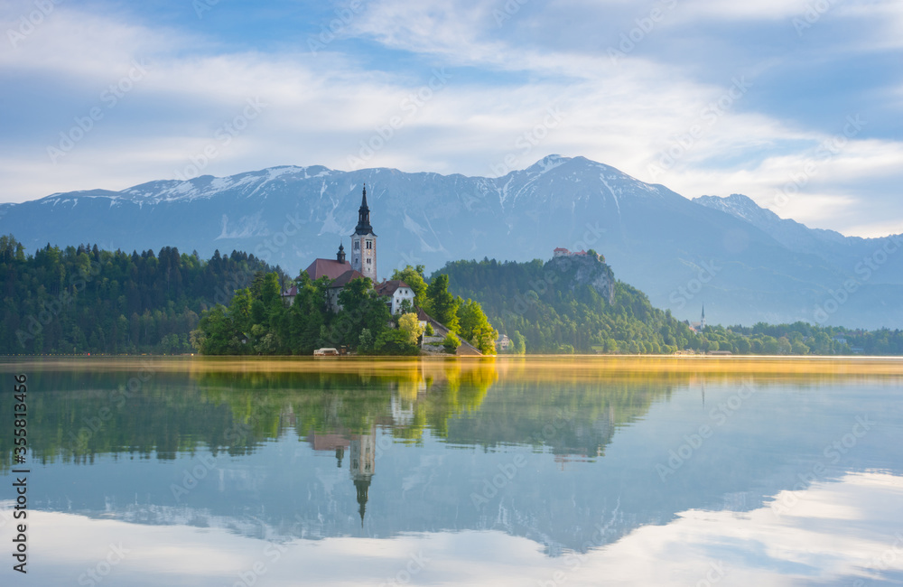 Beautiful morning at Lake Bled and Julian Alps in the background. The ...