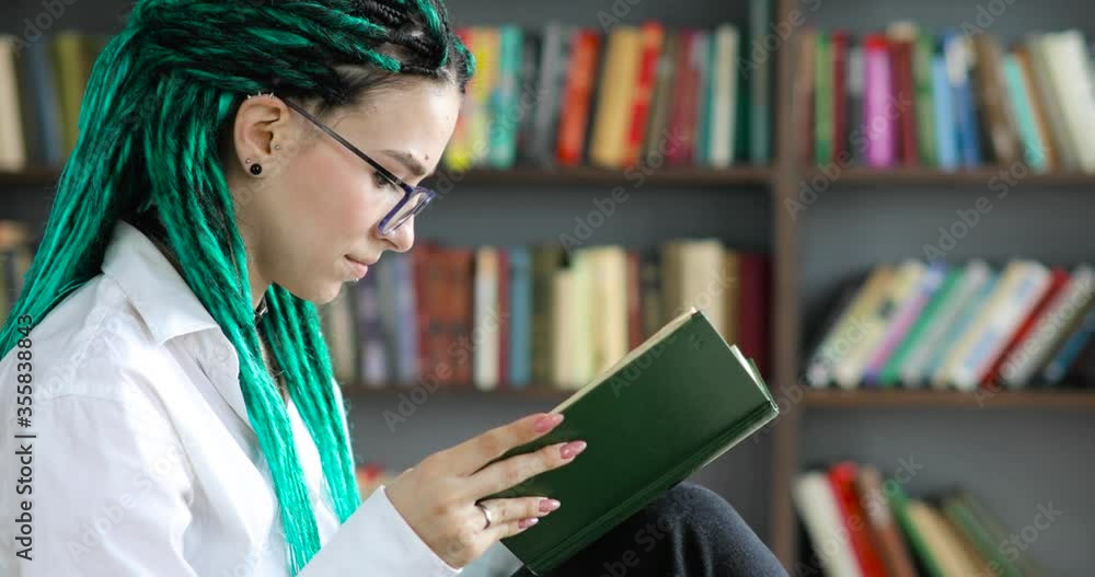 Portrait of young girl student with dreads hairs in glasses reading ...