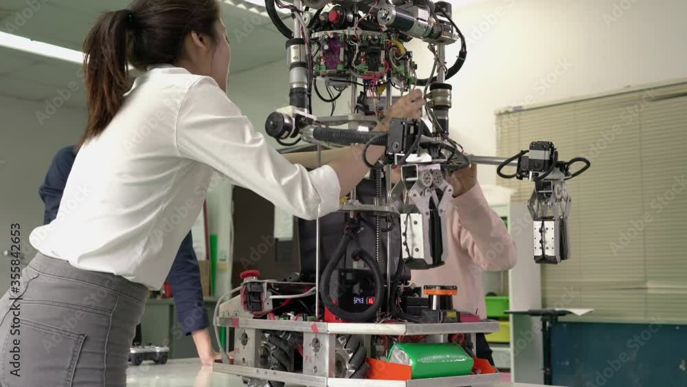 Asian engineer collaborating development robot in modern laboratory ...