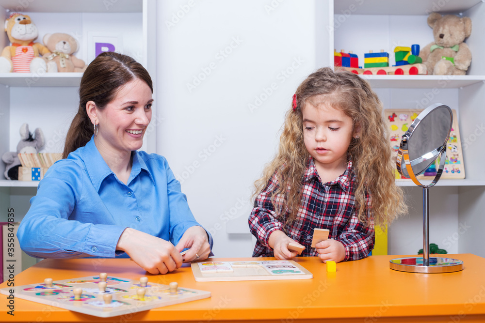 Toddler girl in child occupational therapy session doing sensory ...