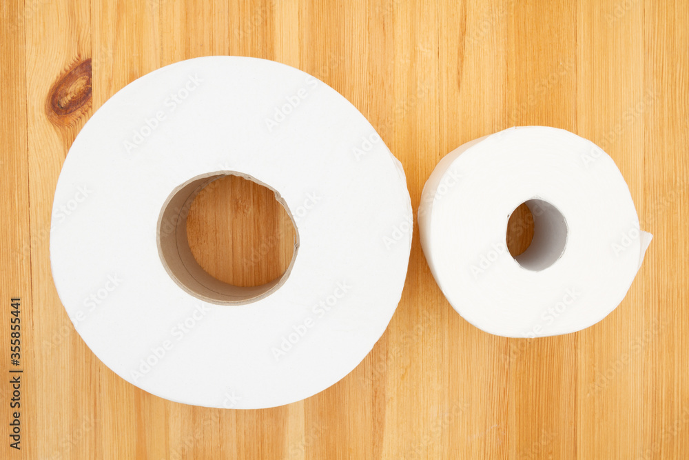 Very large and normal size toilet paper roll Stock Photo | Adobe Stock