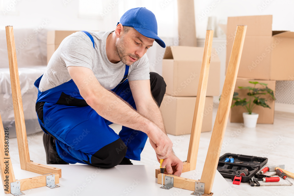 Carpenter Working Assembling Desk Installing Furniture After Relocation ...