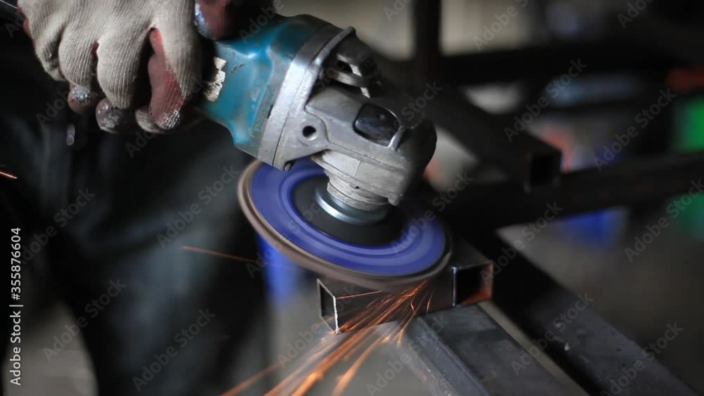 Grinding metal in the workshop. Work with an electric tool. Circular ...