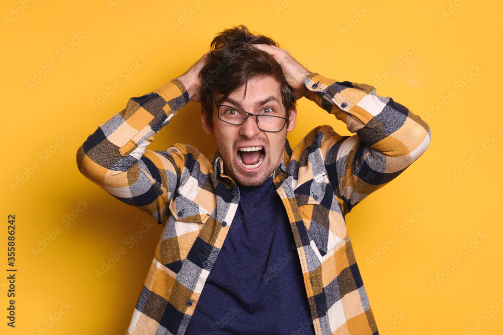 Studio portrait of stressed man in angry, experiencing stress, madness ...