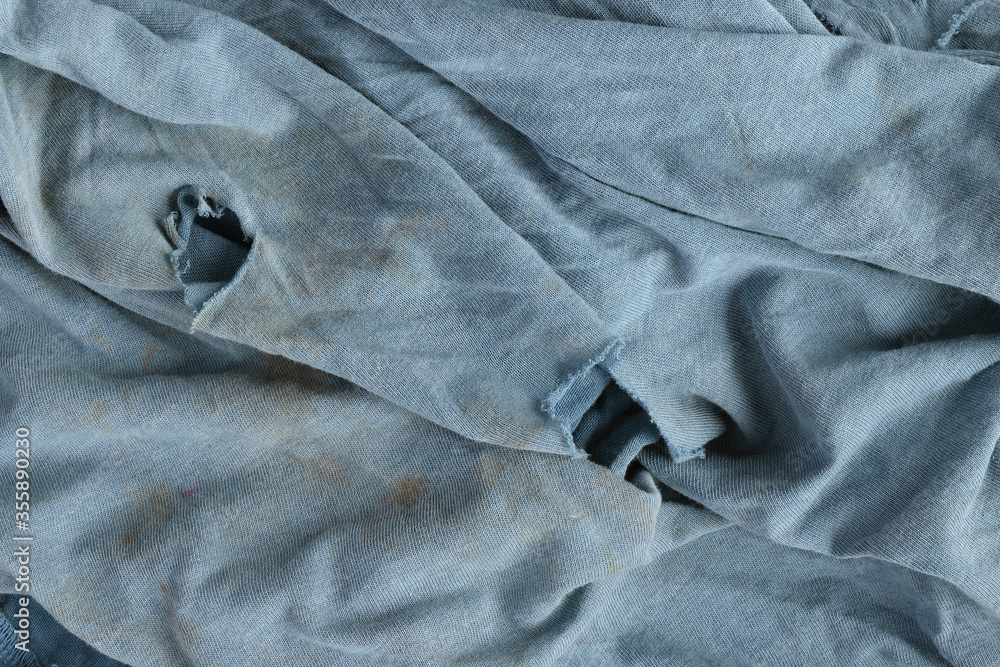 Old dirty ragged cloth texture. Blue gray fabric with brown spots and ...
