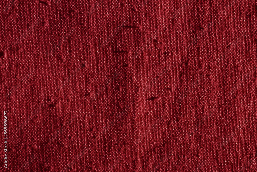Texture of a dark red linen fabric with many defects. Old uneven ...