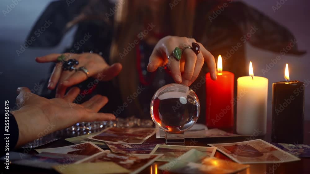Prediction ritual in dark room with magic crystal ball and candles ...