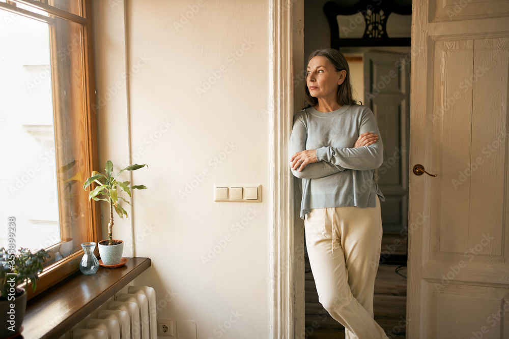 Indoor Shot Of Serious Sad Middle Aged Female In Casual Clothes