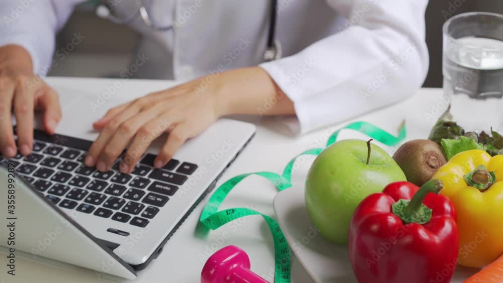 Nutritionist giving consultation to patient with healthy fruit and ...