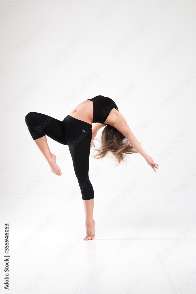 Girl dancer in a pose with a backbend on a white background. Gymnastics ...