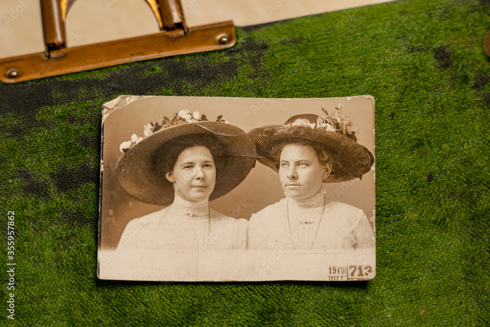 Germany - CIRCA 1912: Photo of two young women wearing hats on green ...