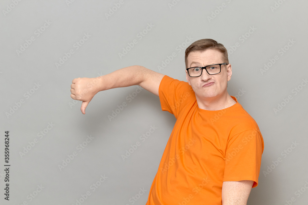 Portrait of funny man giving thumb down sign of disapproval Stock Photo ...