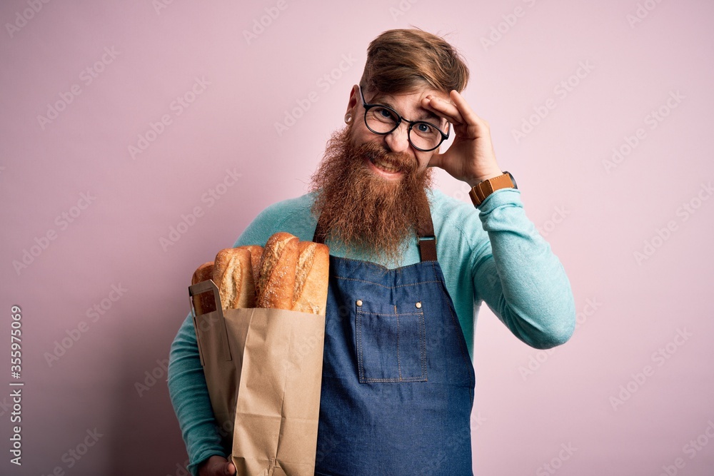 Irish redhead baker man with beard holding groceries paper bag of bread ...