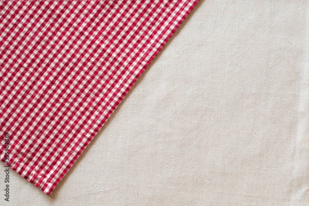 Red and White Checked Cloth at angle on upper corner of off white or ...