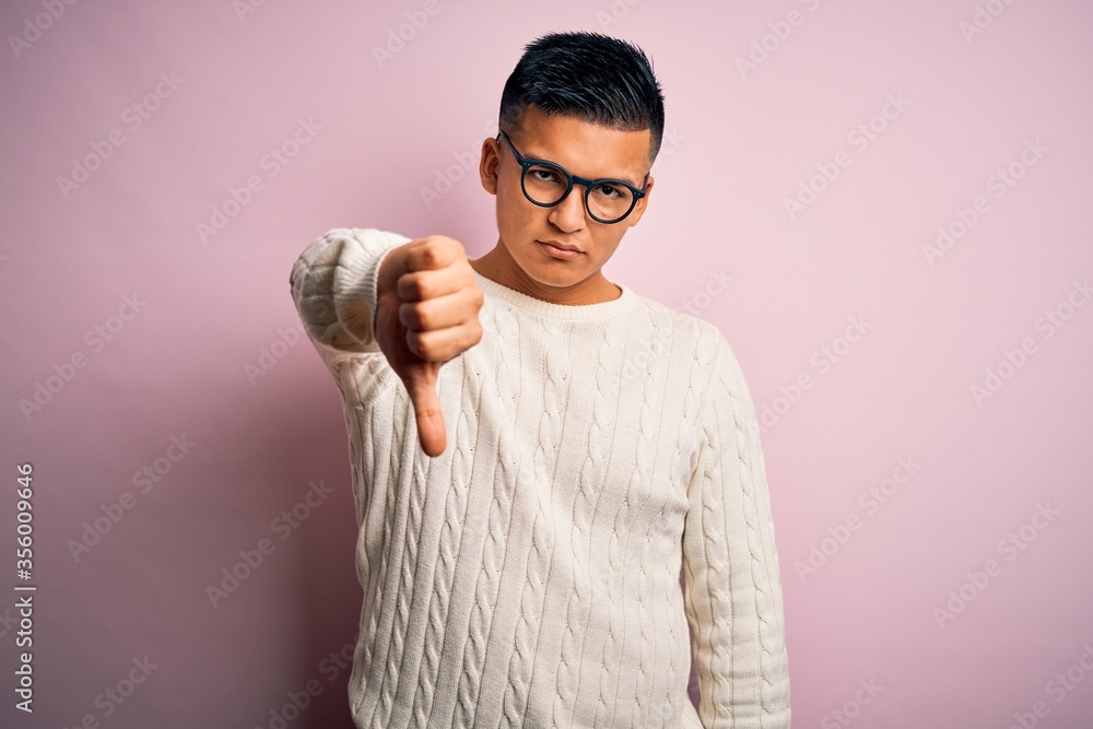 Young handsome latin man wearing white casual sweater and glasses over ... Young handsome latin man wearing white casual sweater and glasses over ...