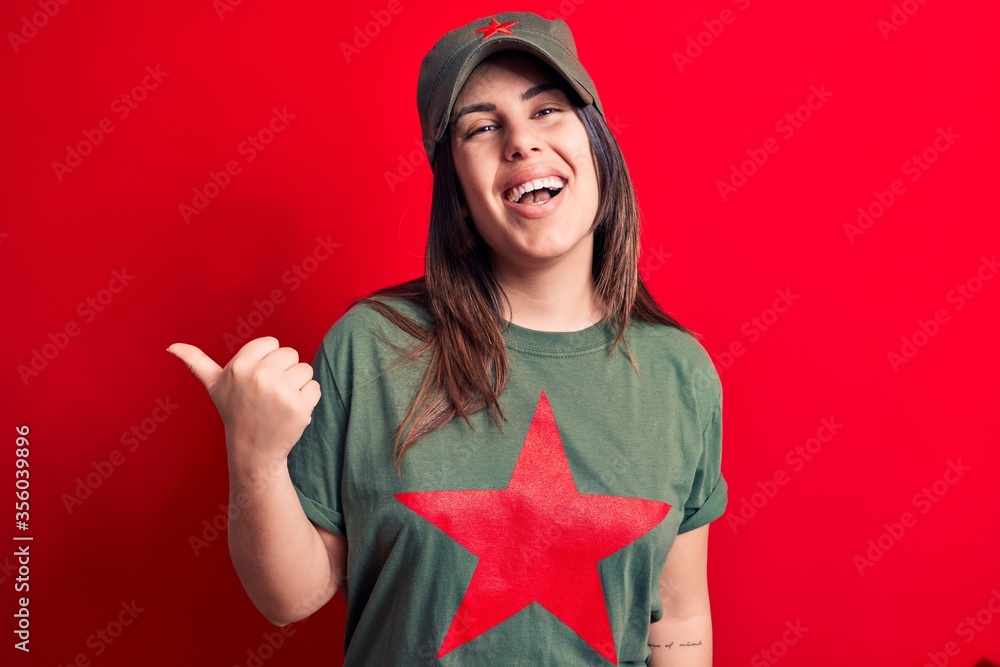 Young beautiful brunette woman wearing cap and t-shirt with red star ...