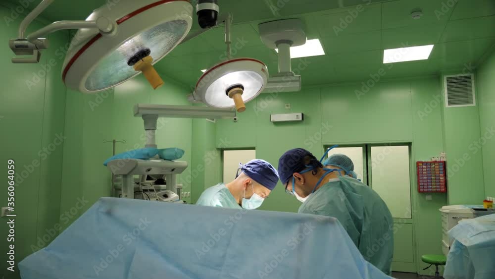Surgical team during the operation. Surgery procedure in the green ...