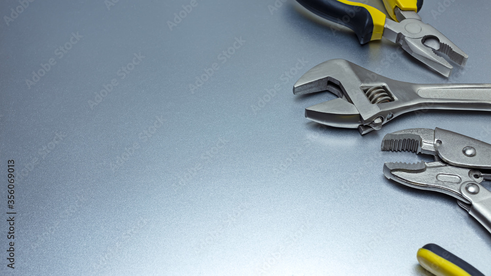 different fixing tools on grey metallic background. construction, house ...