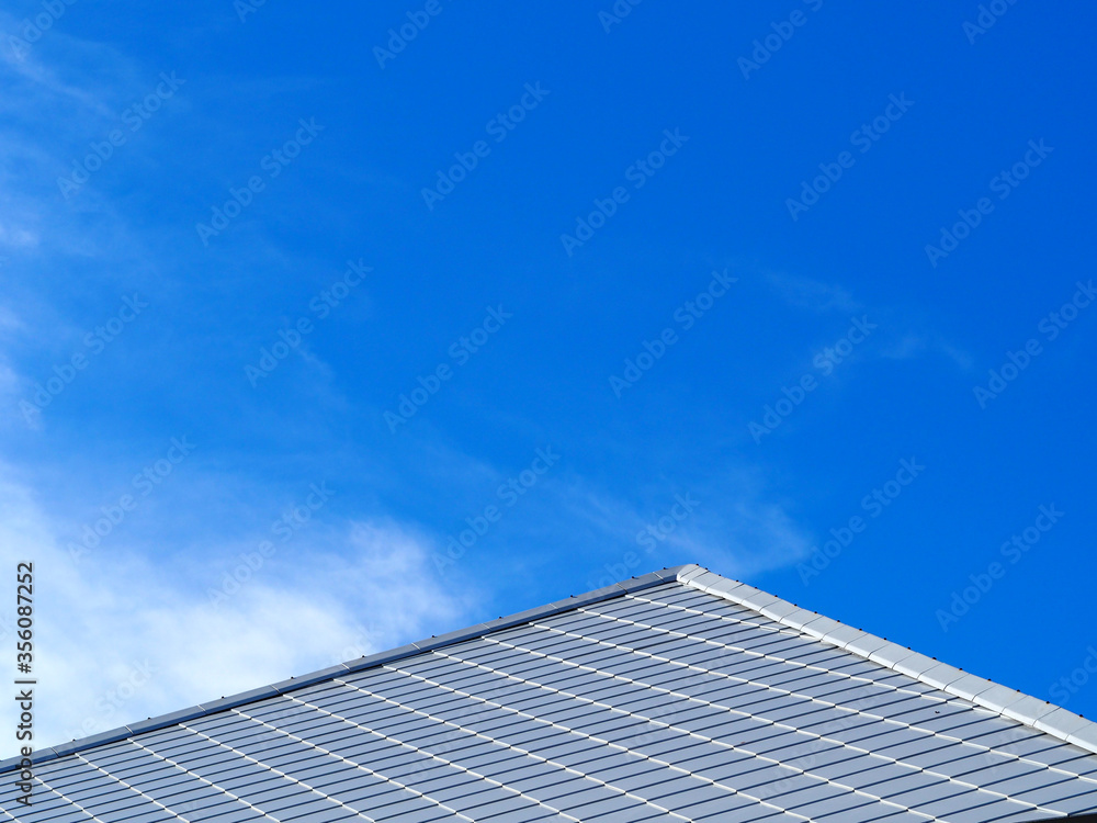 Slate roof and slope with clouds and blue sky background.Tile roof of ...