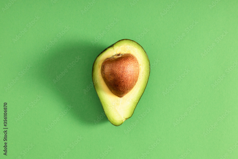 Avocado minimal pattern. Half green avocado on light green background ...